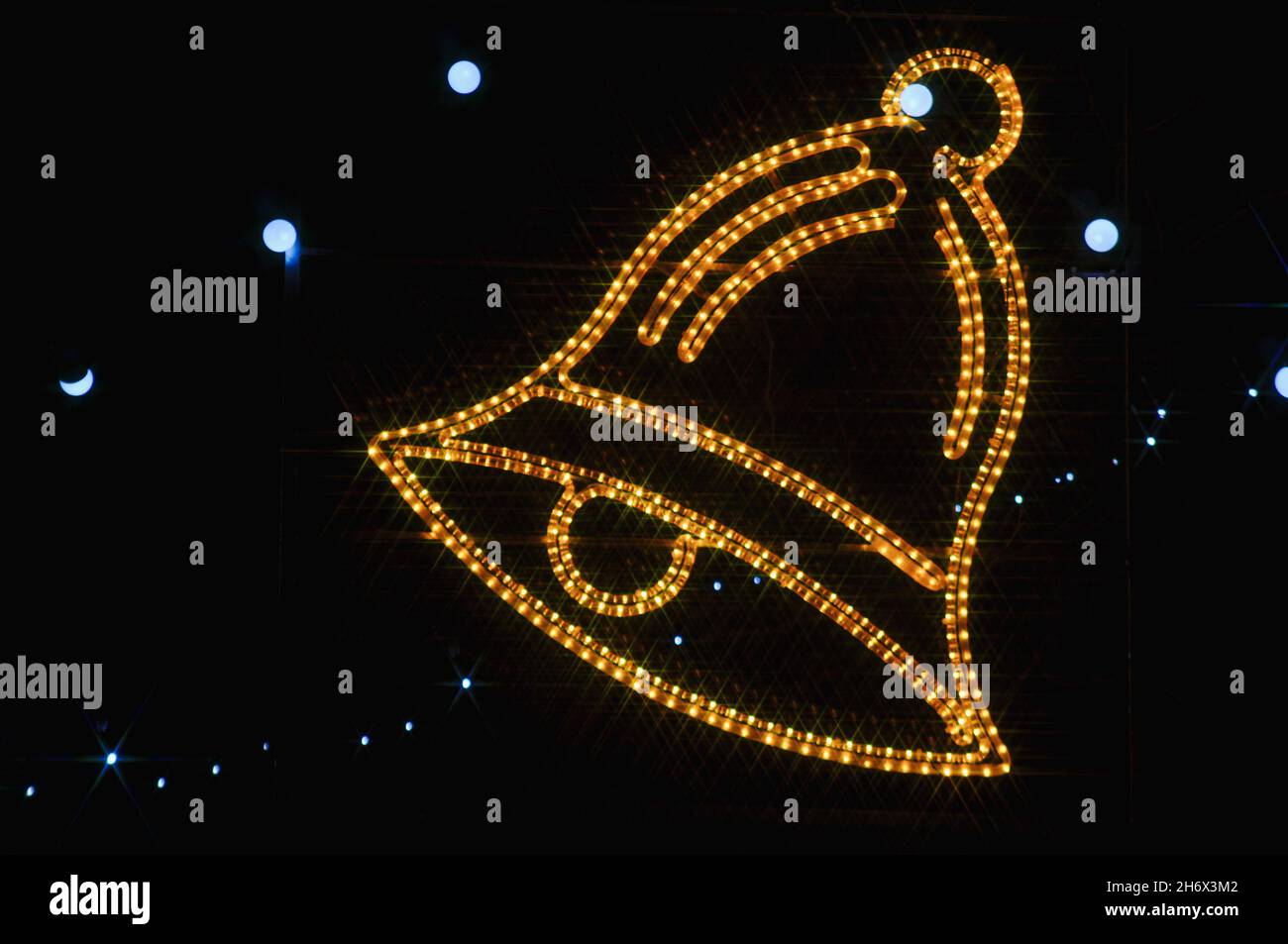 Shiny bell Christmas decoration on a dark street Stock Photo - Alamy