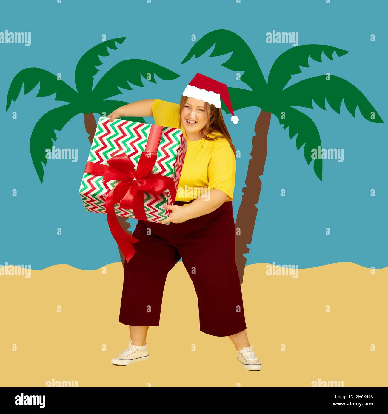 Happy smiling woman with huge gift box greets Christmas at desert ...