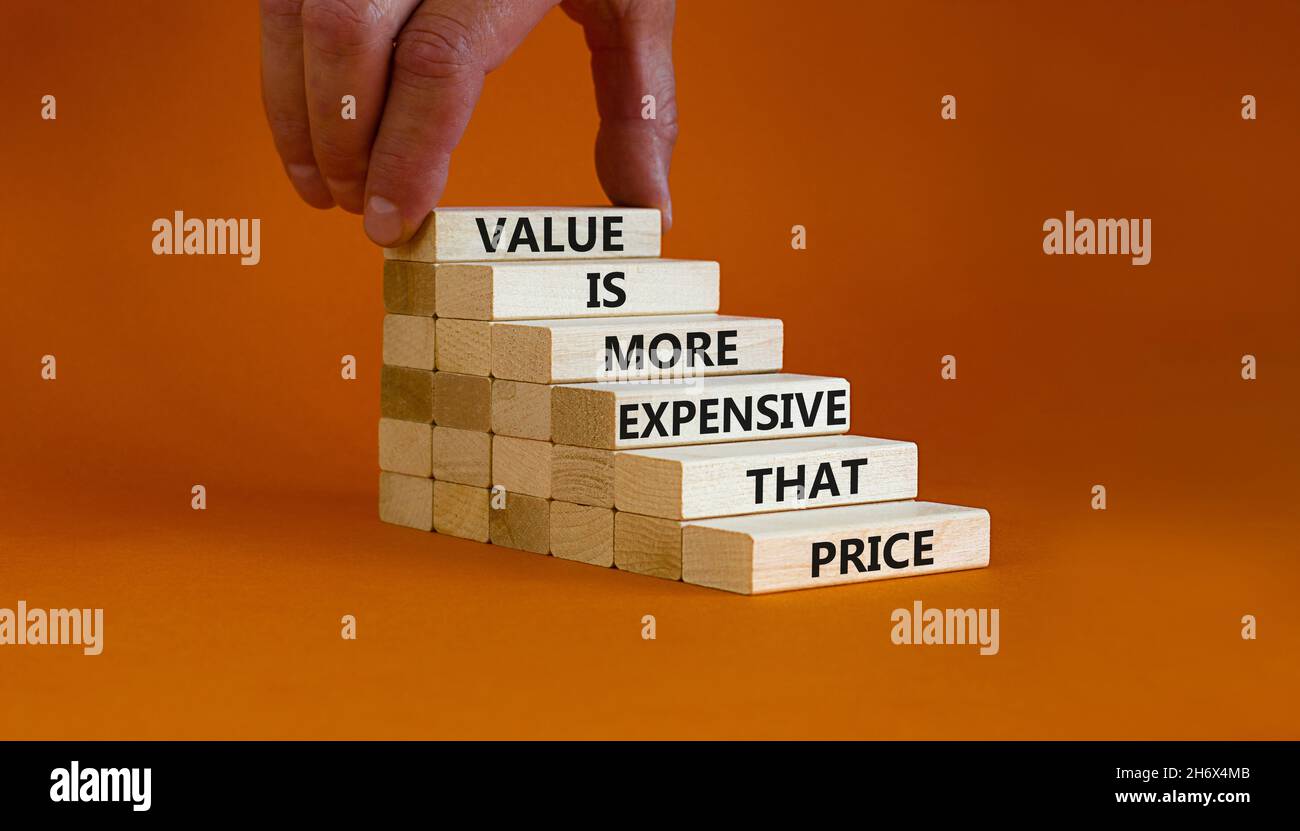 Price or value symbol. Wooden blocks with concept words Value is more ...