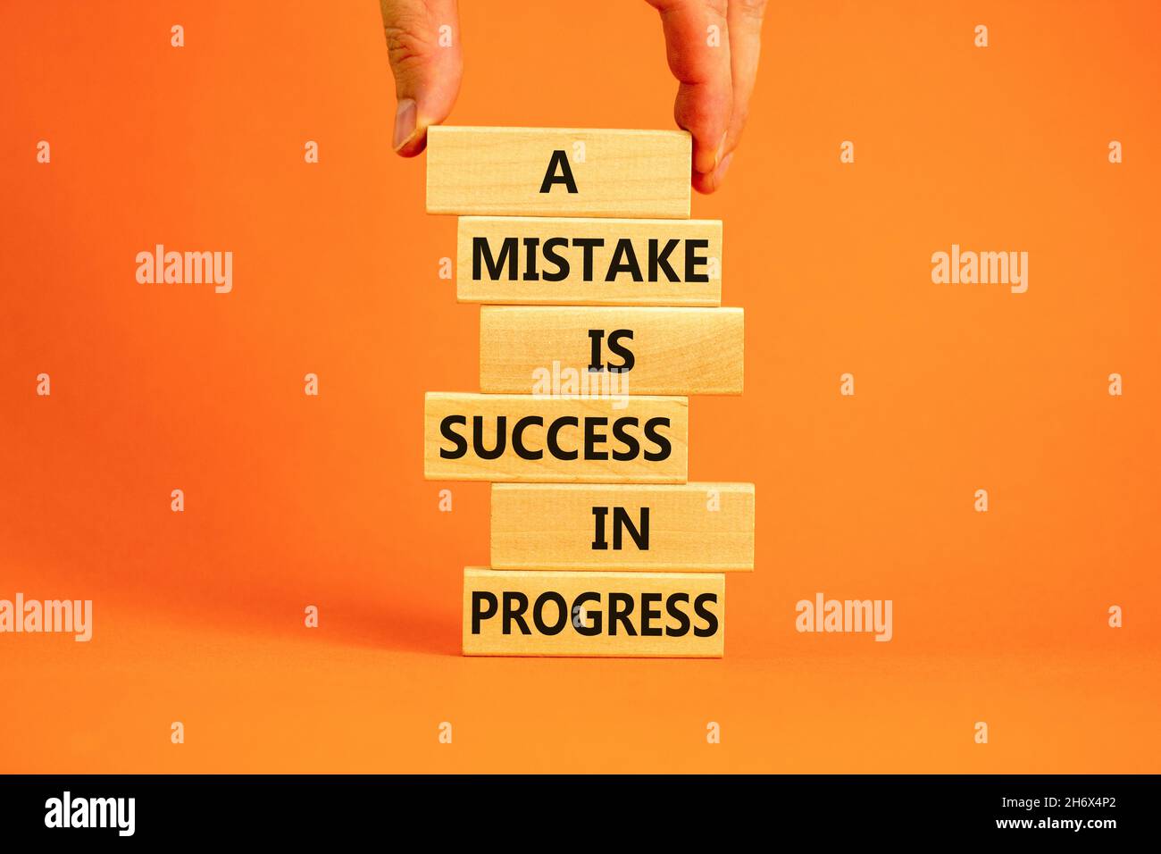 Mistake or success symbol. Wooden blocks with words A mistake is ...