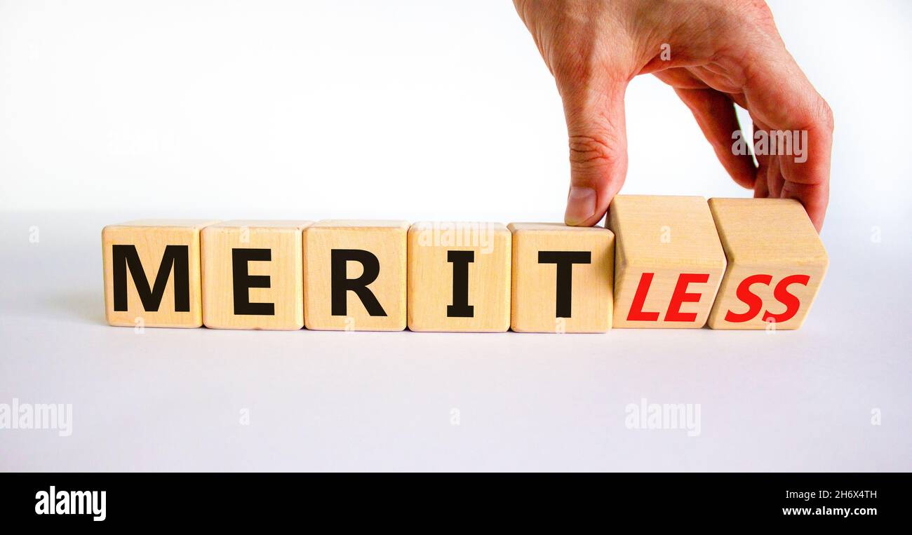 Merit or meritless symbol. Businessman turns wooden cubes and changes ...