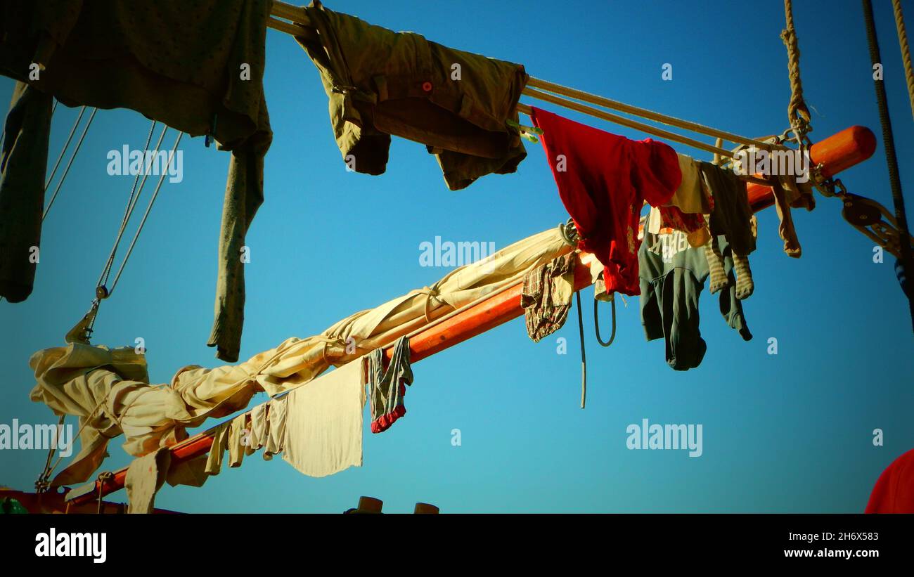 laundry drying differently on a sailing ship Stock Photo - Alamy