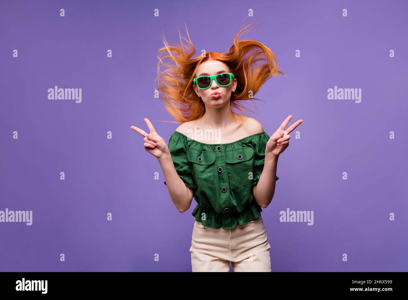 Photo of adorable flirty young lady wear green blouse showing v-signs ...