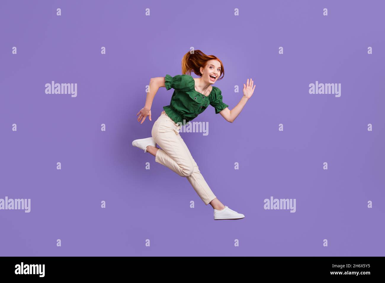 Photo of shocked sweet young lady wear green blouse jumping high ...
