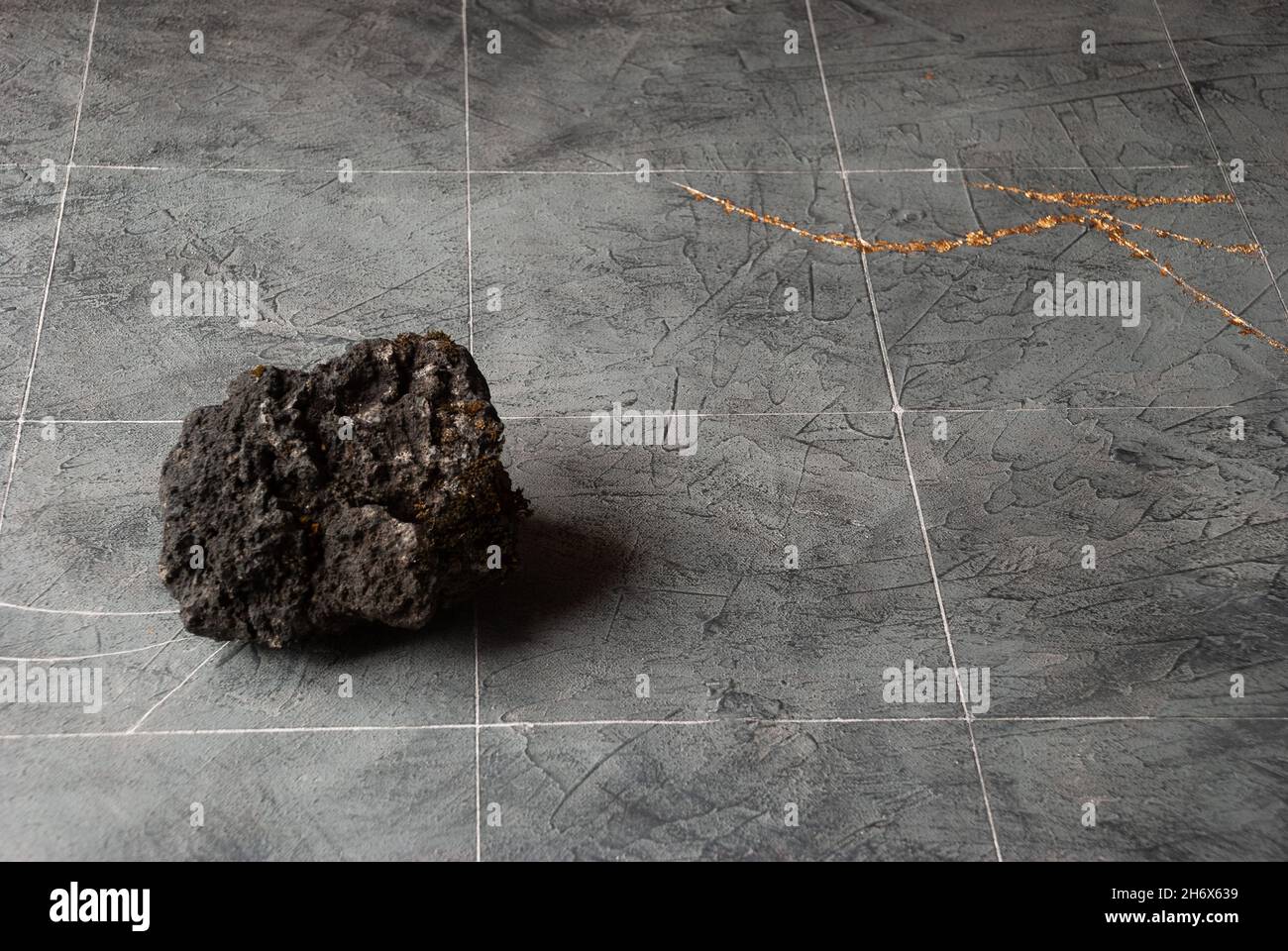 Putty dark gray background under the tiles in the style of kintsugi ...