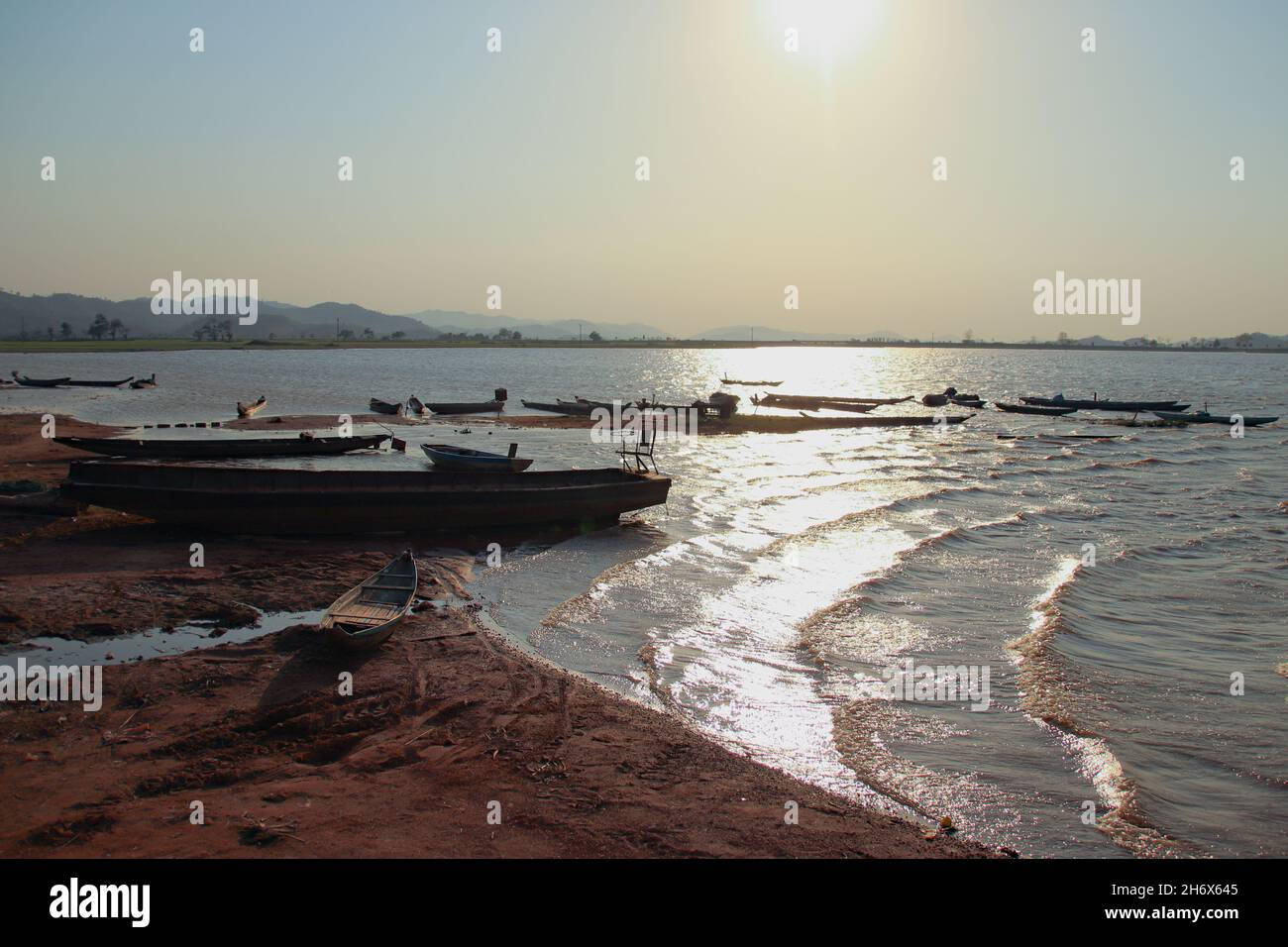 View of fishermen in the sunset over Lak Lake in Dak Lak Province in ...