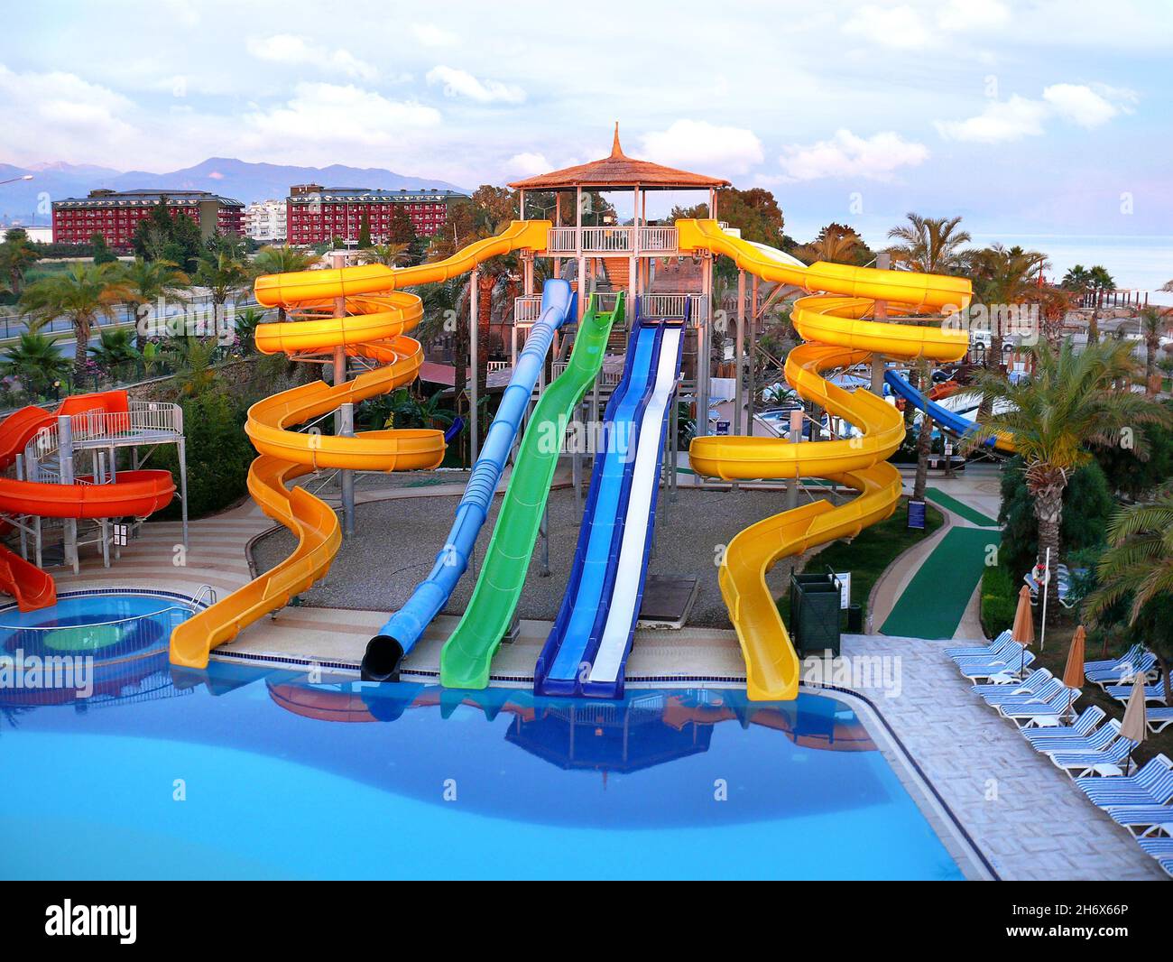 Bright water slides of the water park against the backdrop of the pool ...
