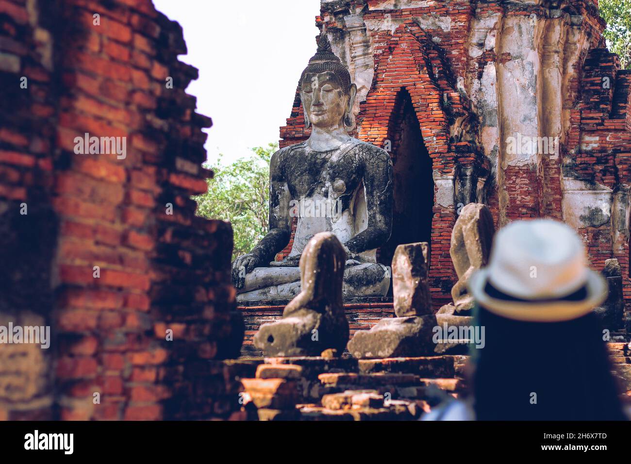 A tourist sightseeing in Wat Choeng Tha, part of the famous Ayutthaya ...