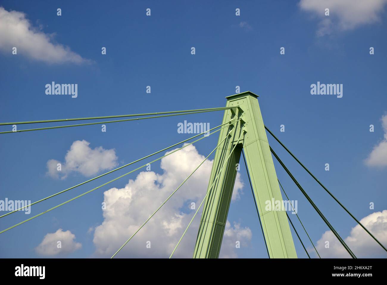 Detail of the pylon tower of a cable-stayed bridge against a blue ...