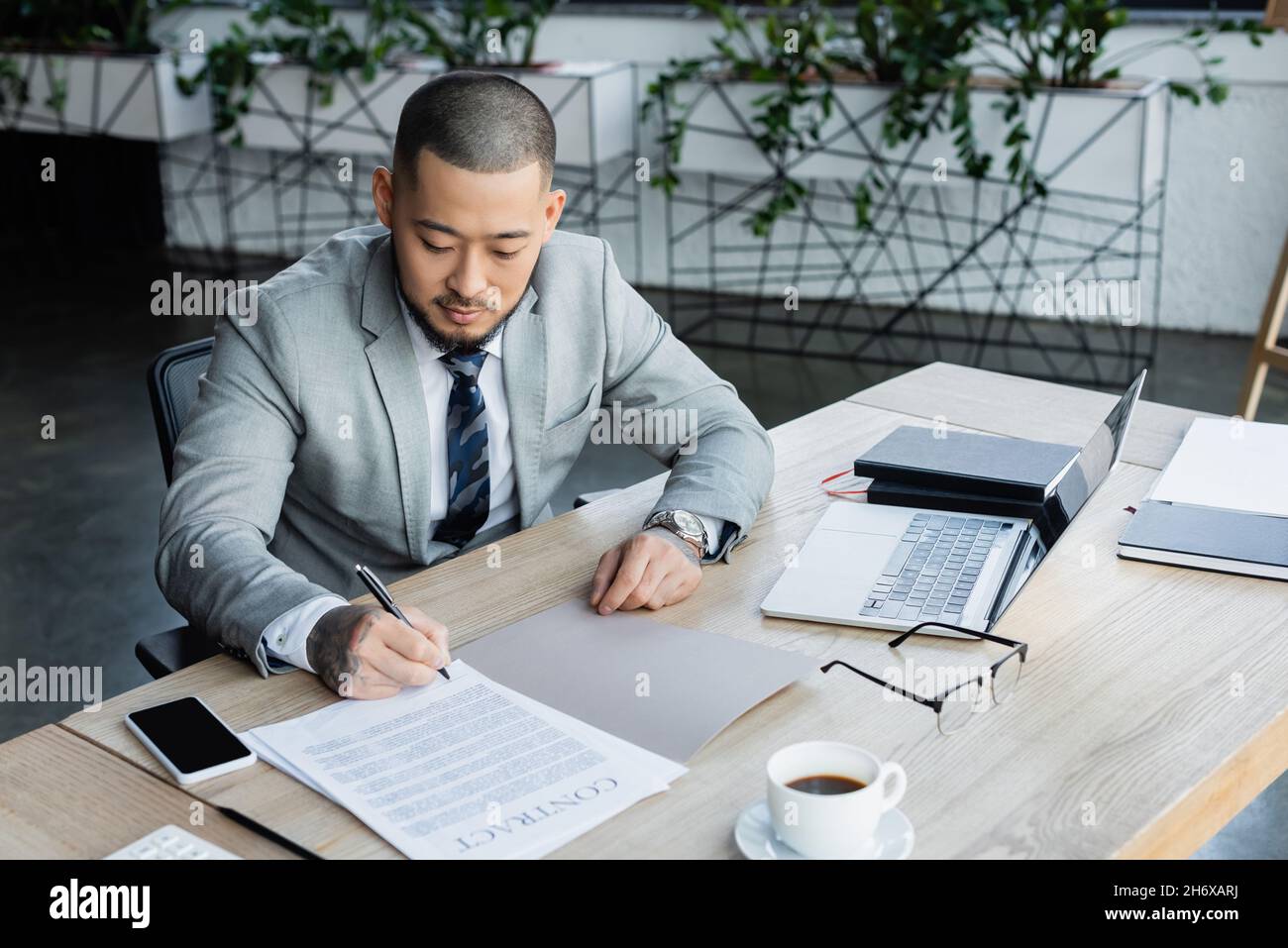 Asian man signing contract hi-res stock photography and images - Alamy