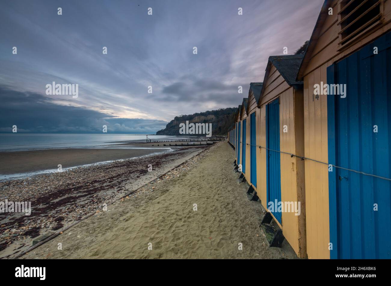 beach huts on the coastline of the isle of wight at shanklin, sunset at ...