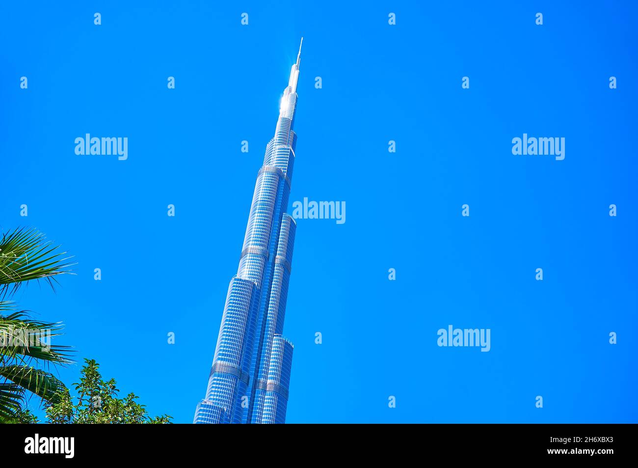 The spire of magnificent Burj Khalifa tower with its glass surface ...