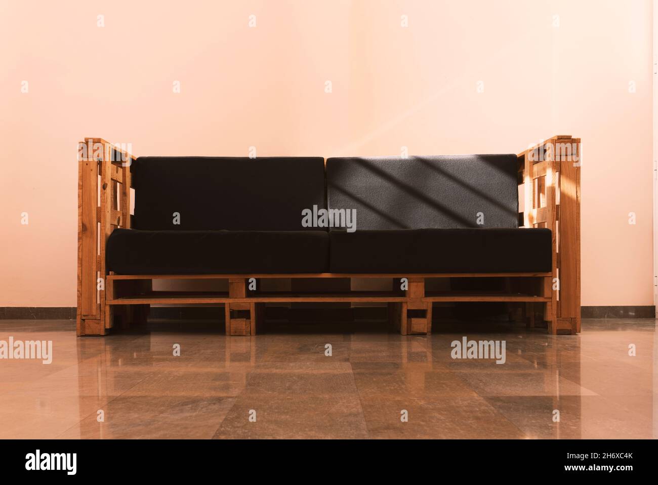 photo of bench made with pallets illuminated by solar rays entering ...