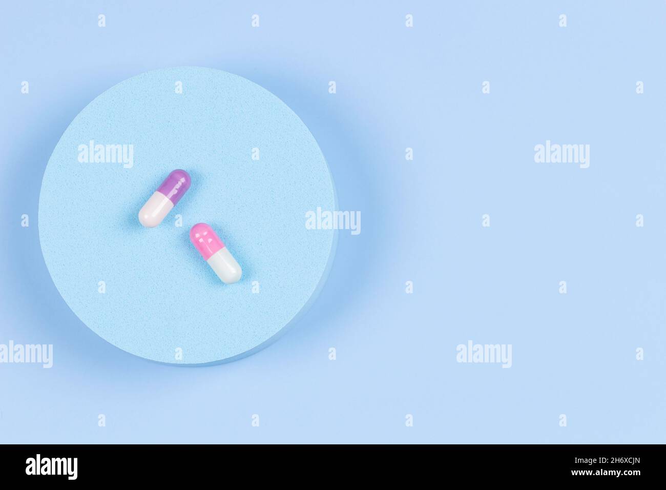 Round geometric shape platform podium with colorful medicine pills ...