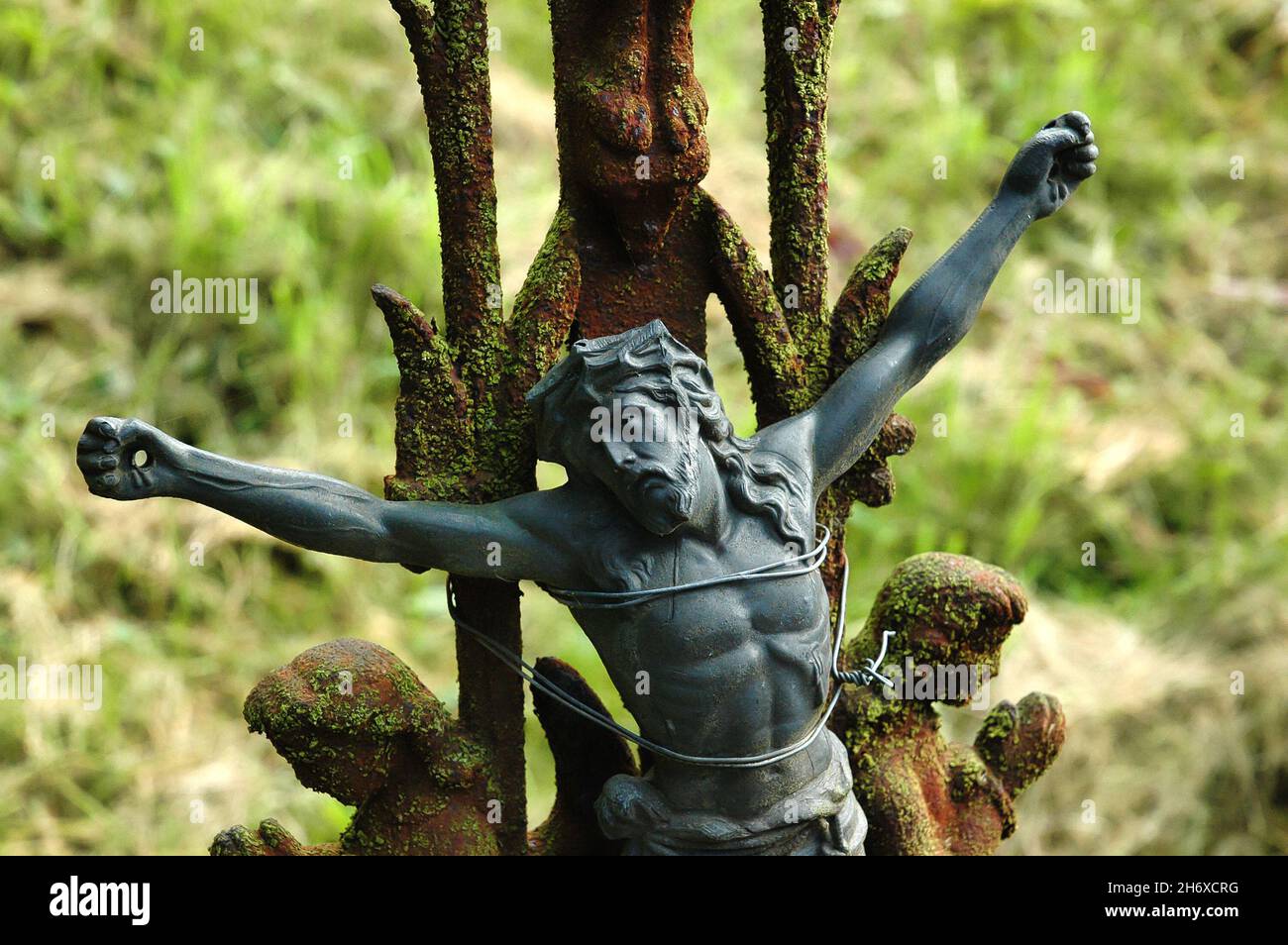 Statue of Jesus is wired on a rusty graveyard fence in northern France ...