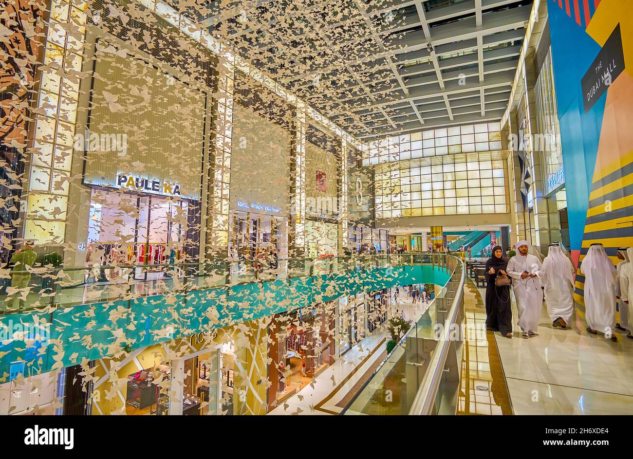 DUBAI, UAE - MARCH 3, 2020: Locals in traditional clothes walk along ...