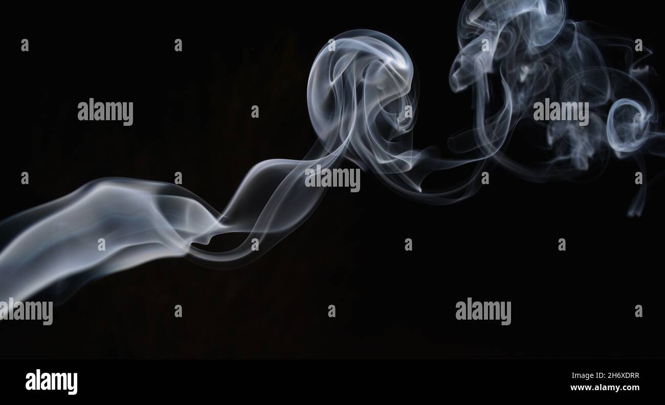 Silky wisps of smoke float off into the cool night air Stock Photo - Alamy