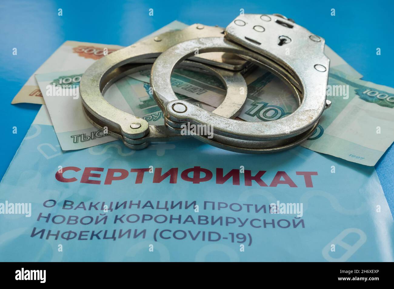 On the blue background there is money, handcuffs and a certificate of ...