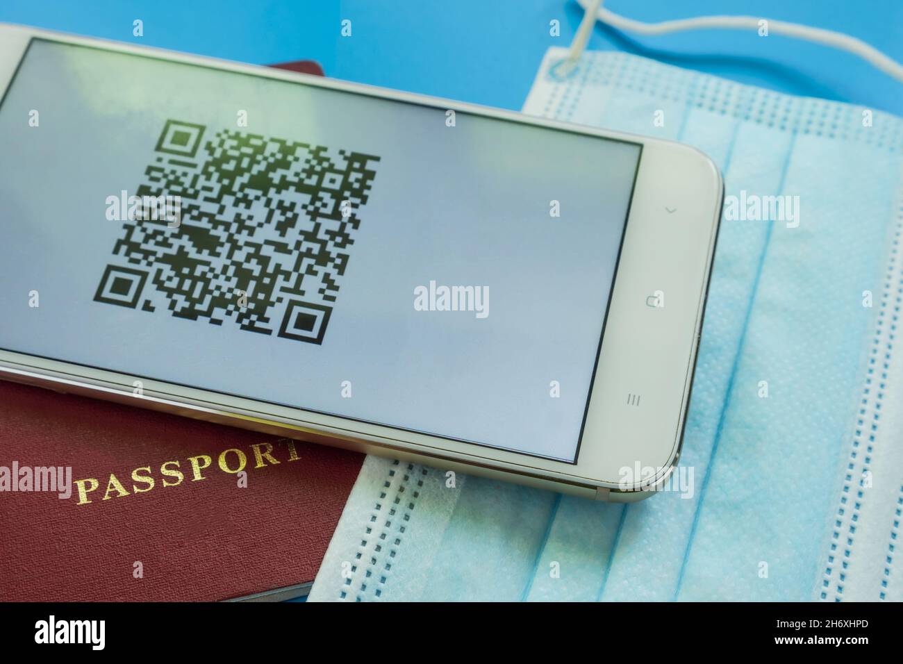 A smartphone with a QR code about the Covid-19 vaccination lies on the ...