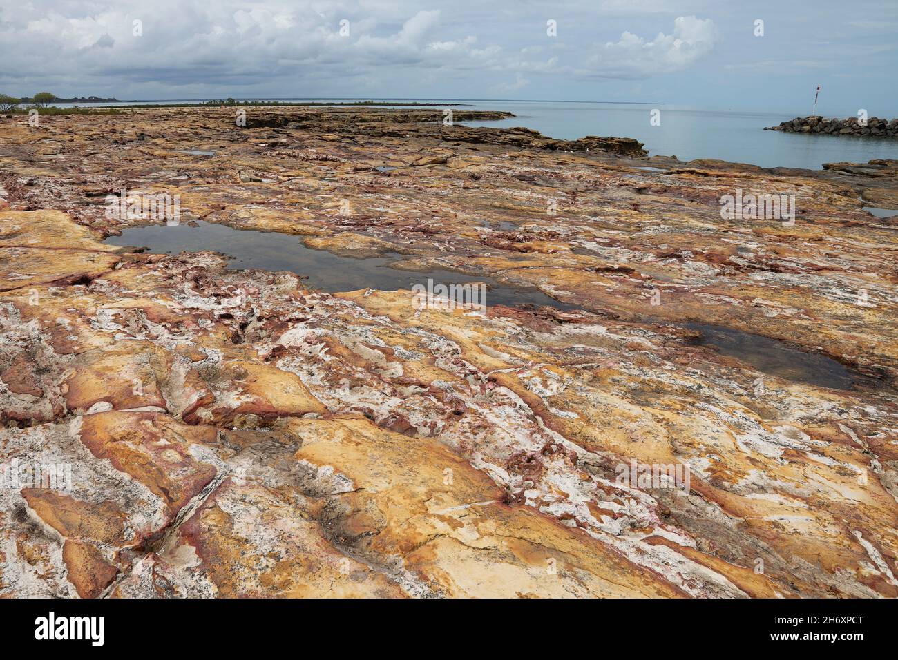 Red-coloured rocky coast at Sunset Park in Nightcliff, Darwin, Northern ...