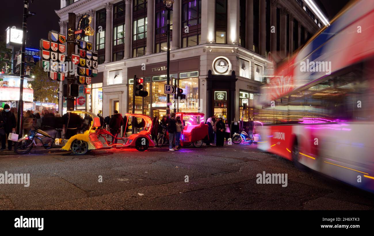 Rickshaws at night beside The Canton Flags in Leicester Square in a ...