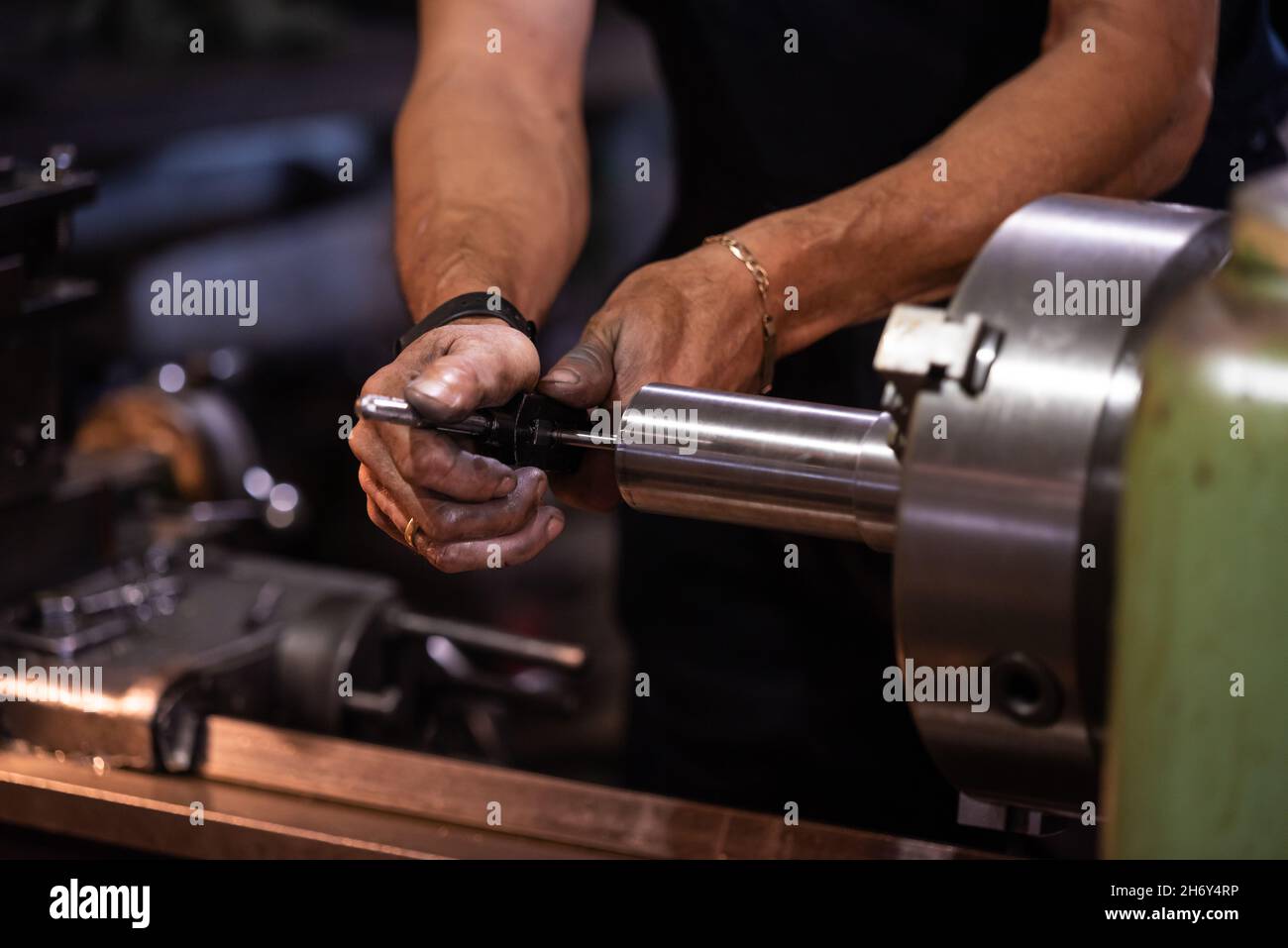 Worker working on steel scraping machines Stock Photo - Alamy