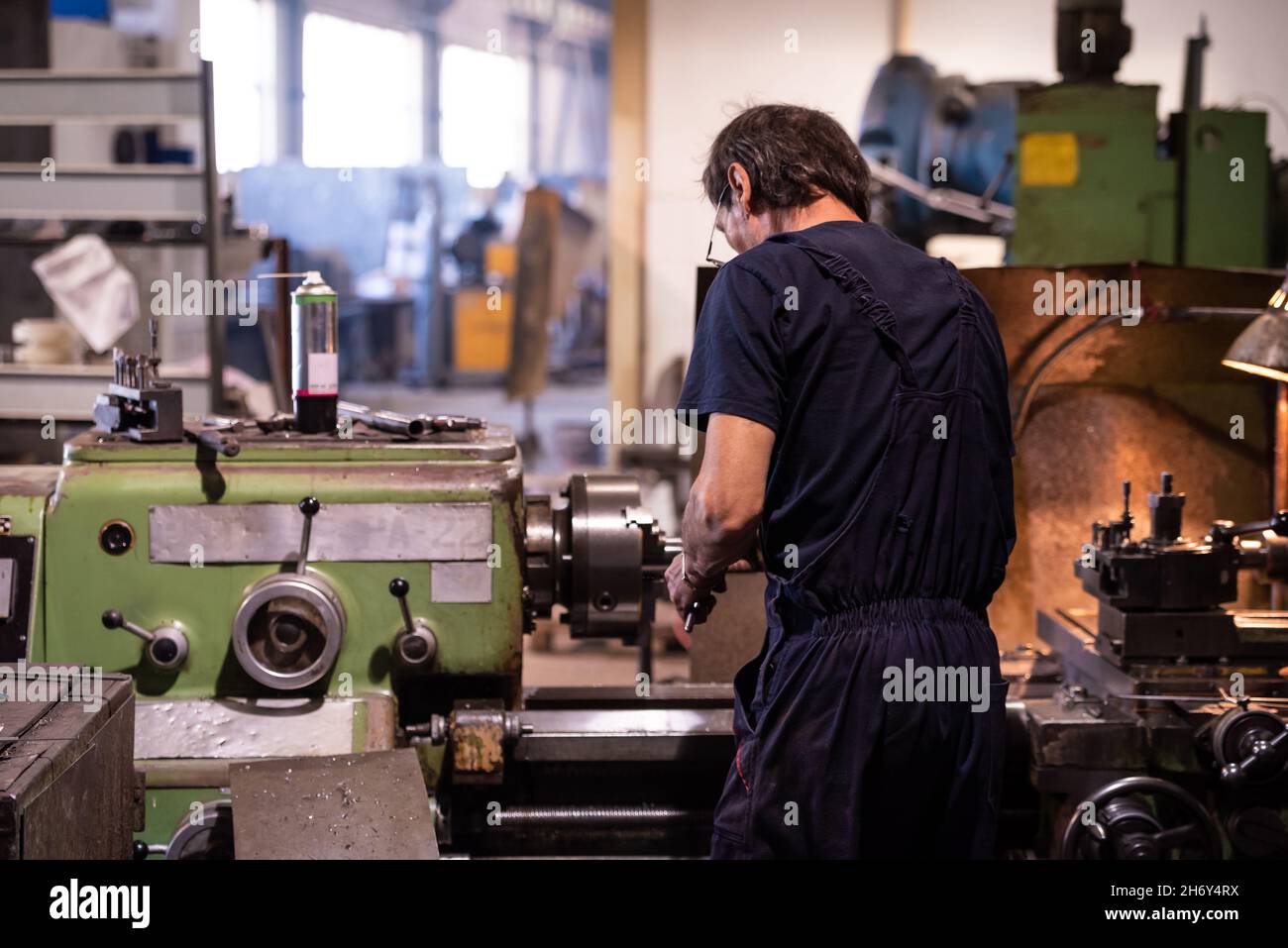 Worker working on steel scraping machines Stock Photo - Alamy