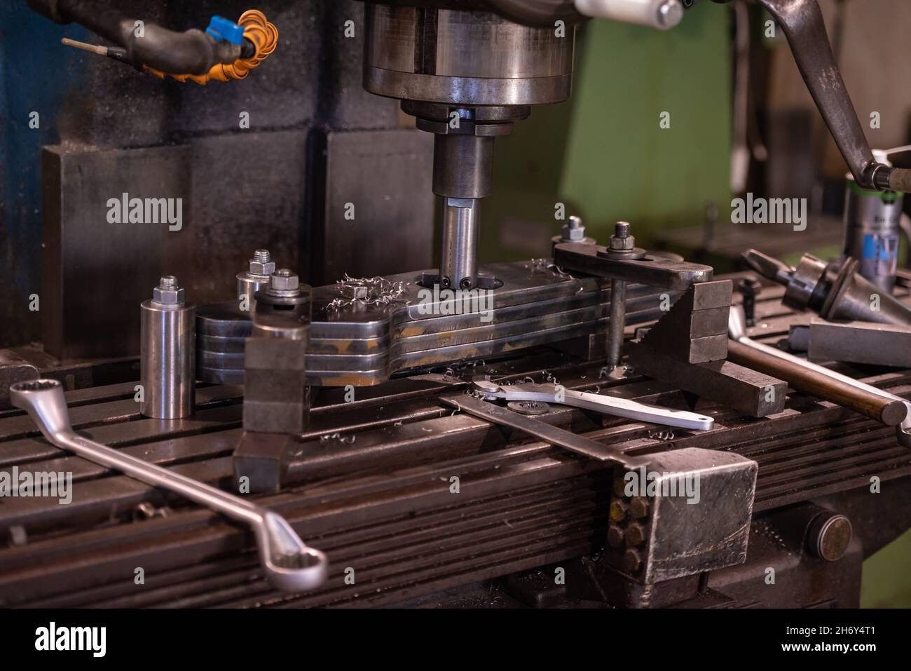 Worker working on steel scraping machines Stock Photo - Alamy