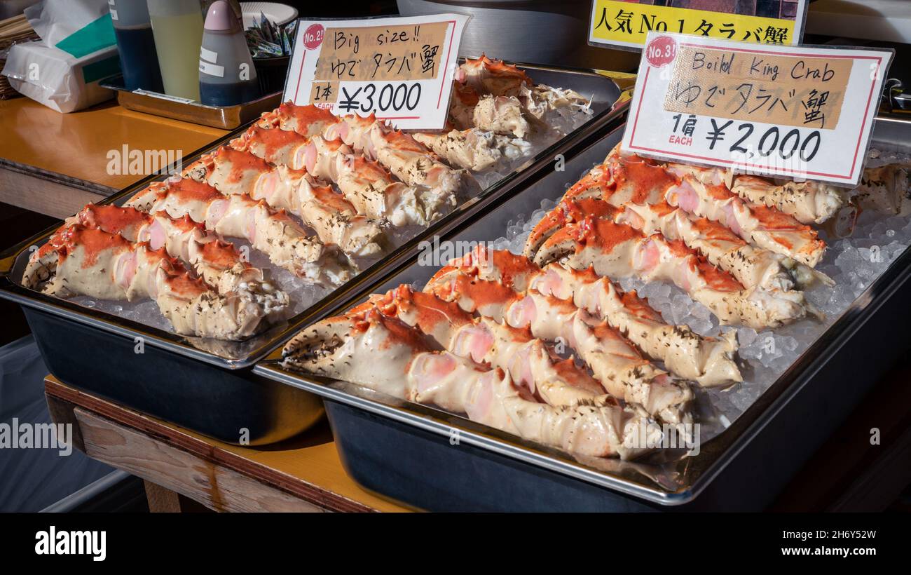 The famous Tsukiji fish market with retail shops sale crab legs and ...