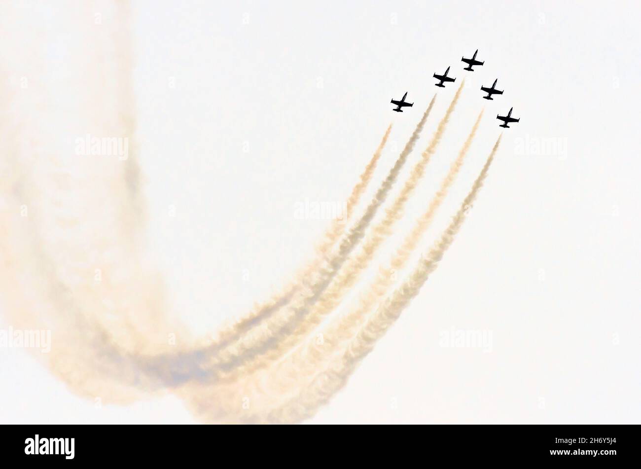 Group of white fighter jet airplane with a trace of white smoke against ...