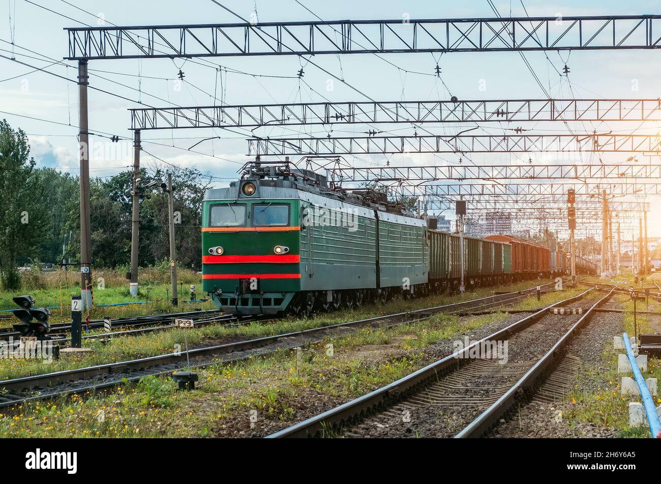 Freight train green with cargo cars on the railway Stock Photo - Alamy