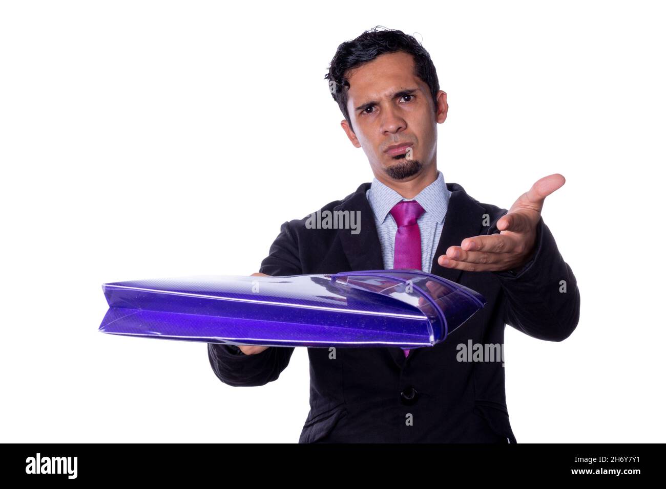 Serious businessman handing a folder with an expression of complaint ...