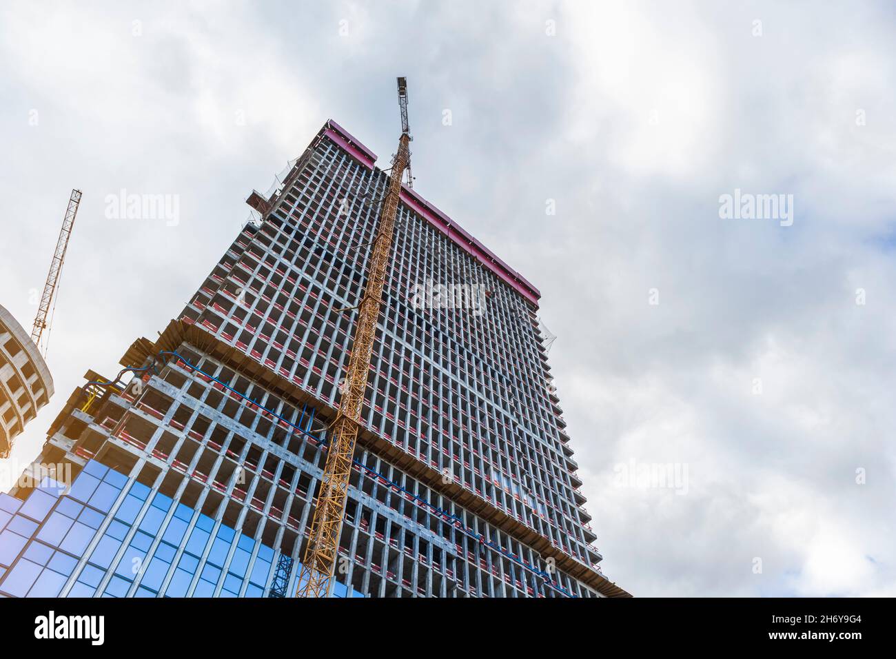 construction of skyscraper tower crane lifting of concrete plinths ...