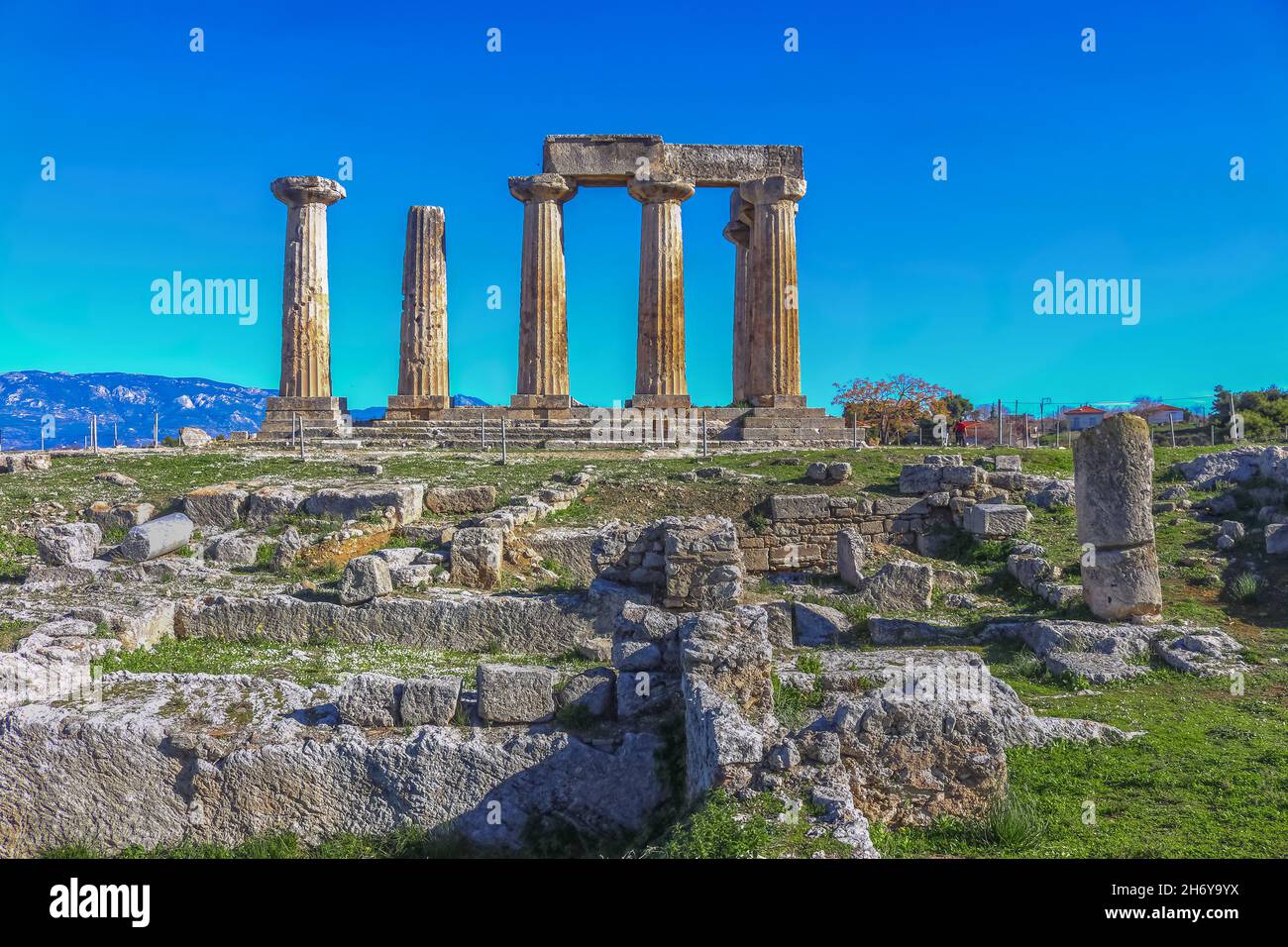 Ruins of Temple of Apollo in Corinth Greece standing up on a hill with ...