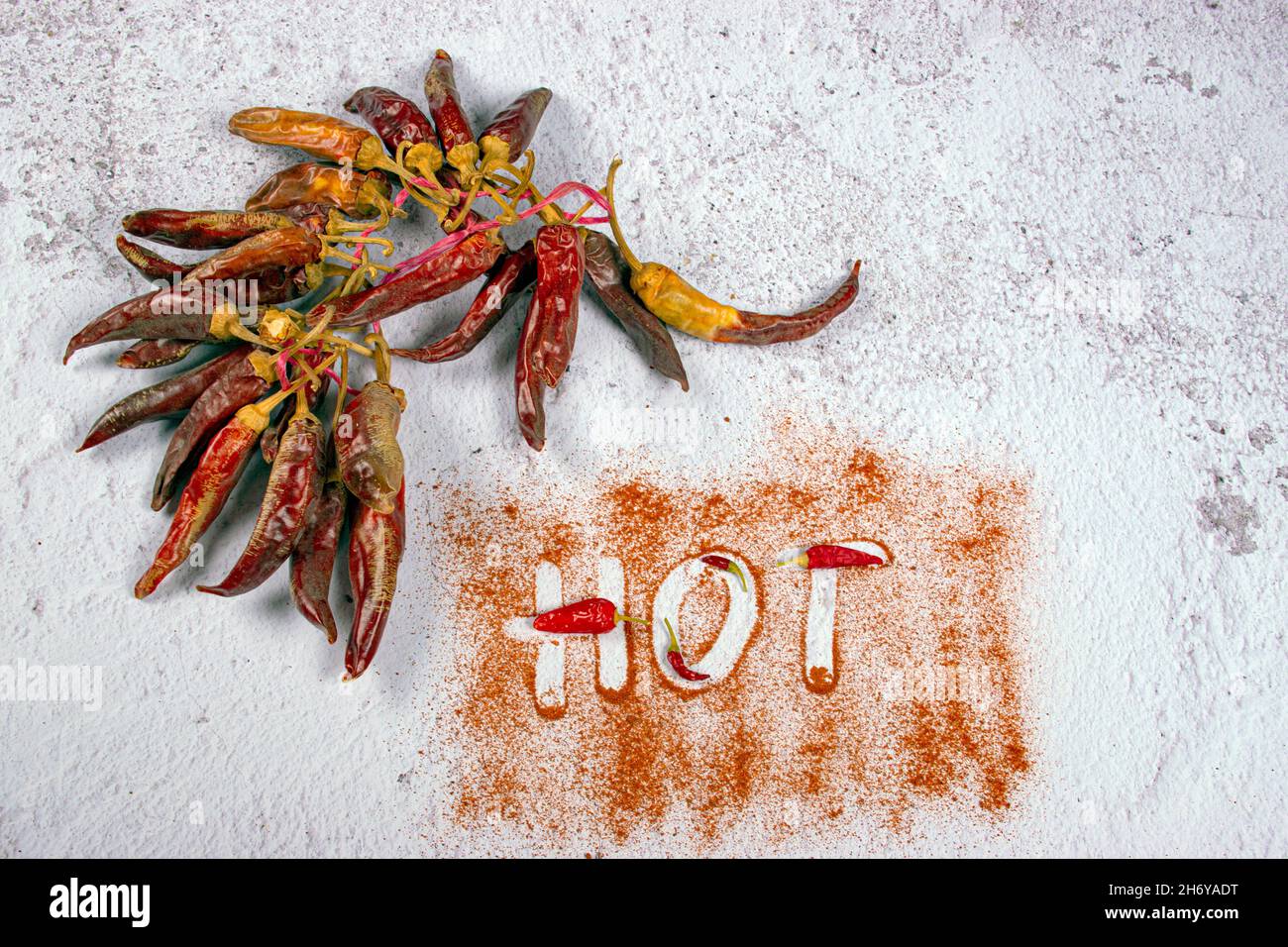 A wreath of hot peppers and ground hot pepper with hot written on a ...