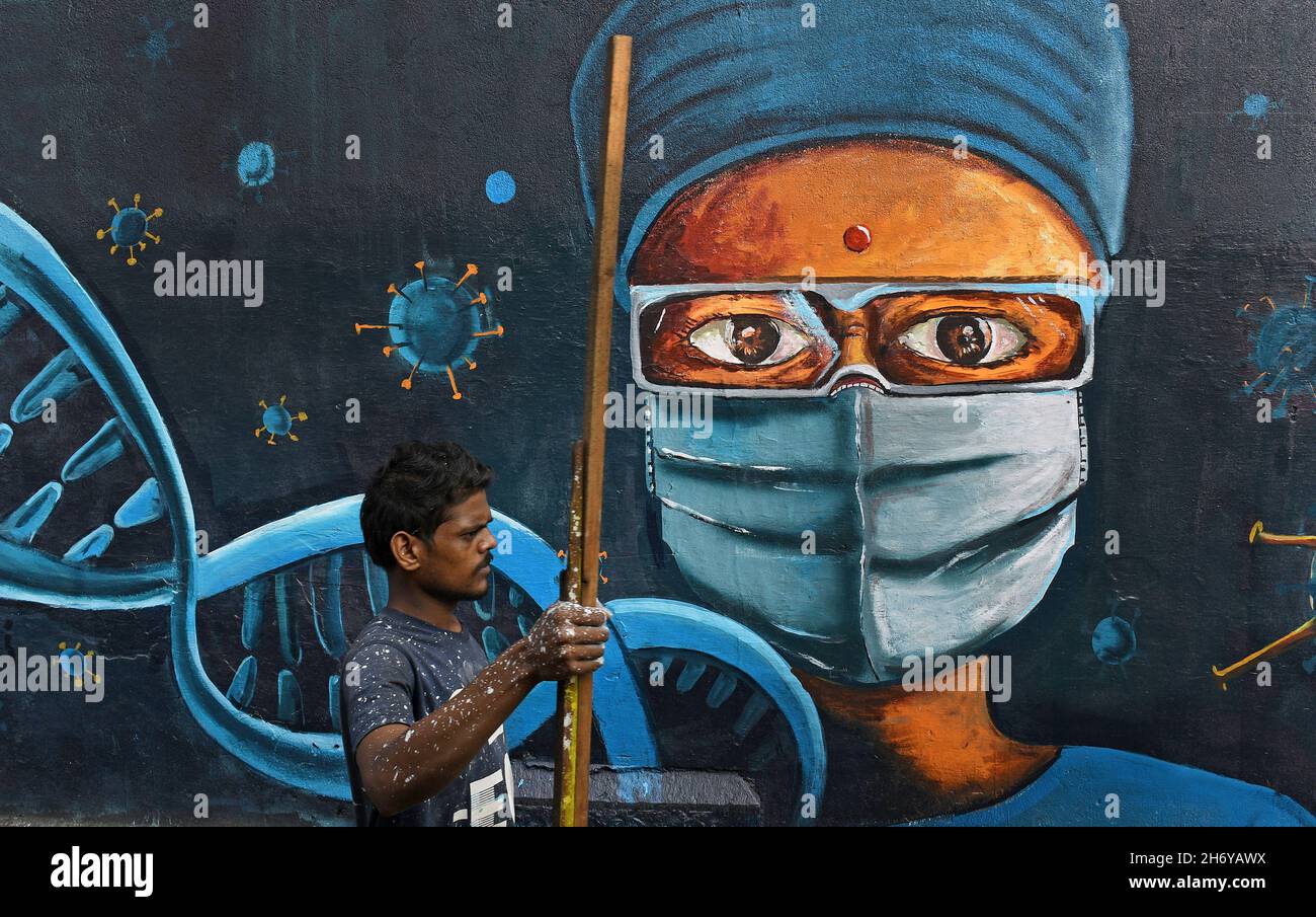 Mumbai, India. 18th Nov, 2021. A man holding a stick walks past a ...