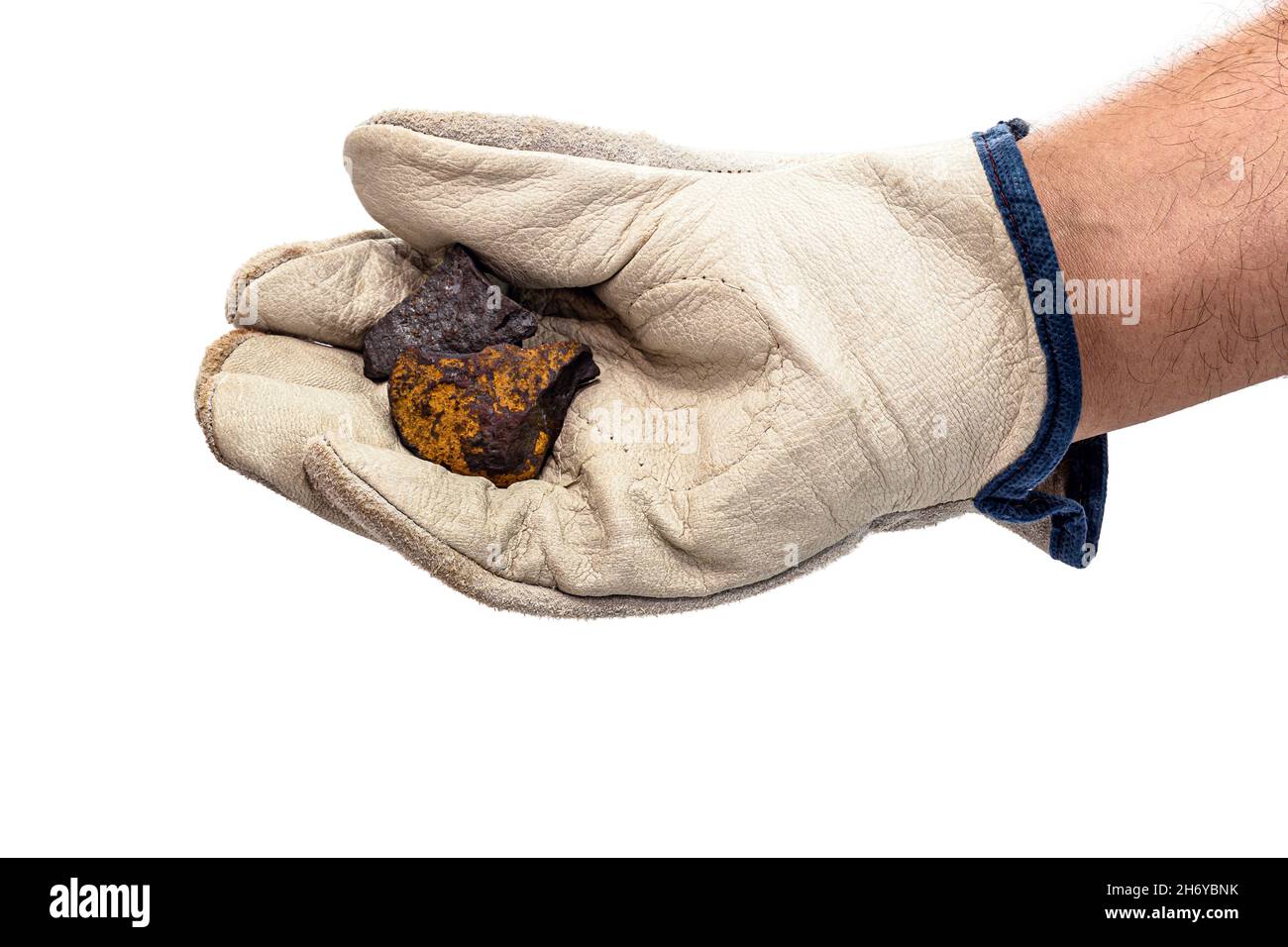 male miner hand holding metallic rock, hematite, mining or geology ...