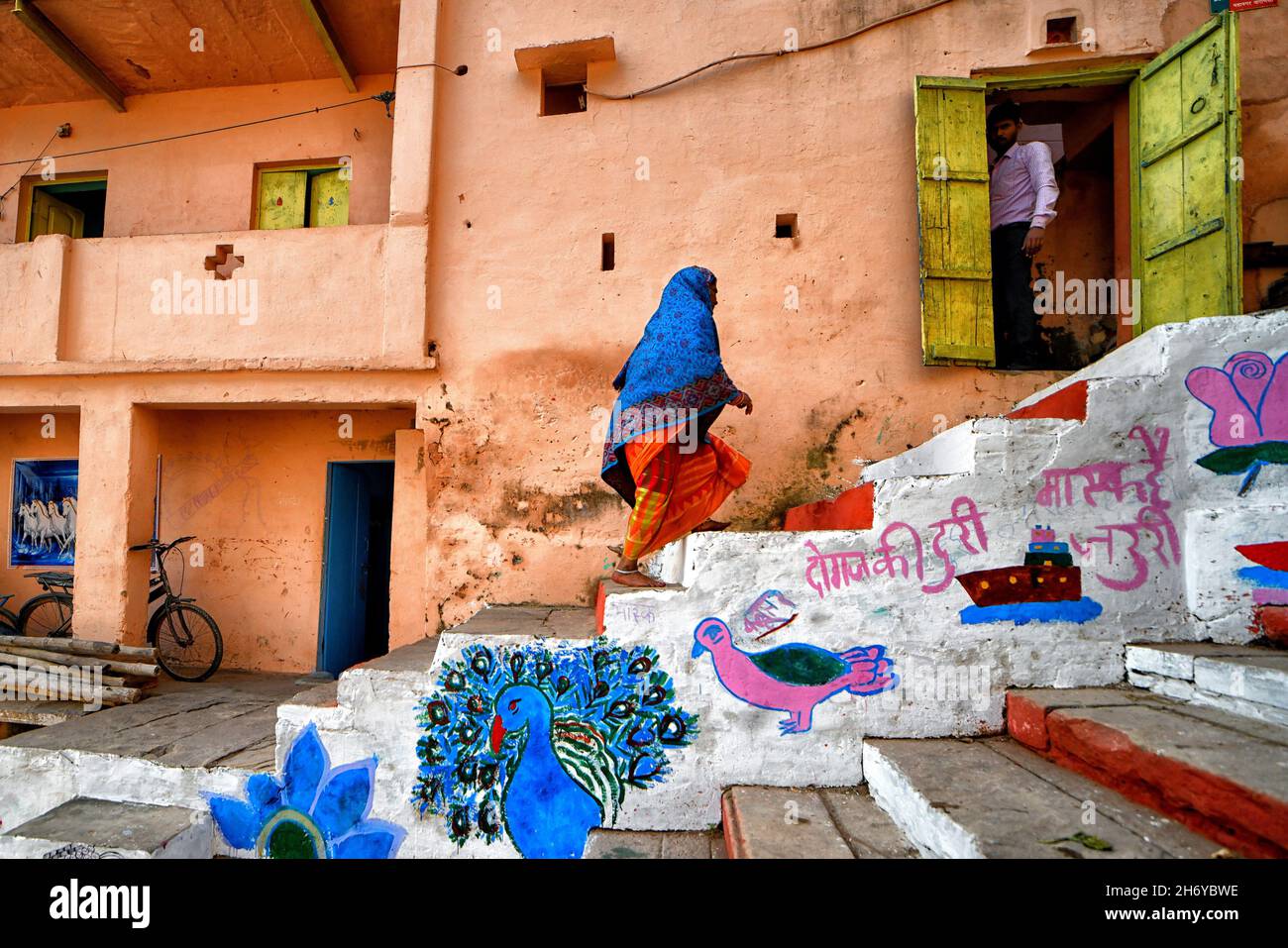 A woman seen walking through the colorful lanes of Varanasi Stock Photo ...