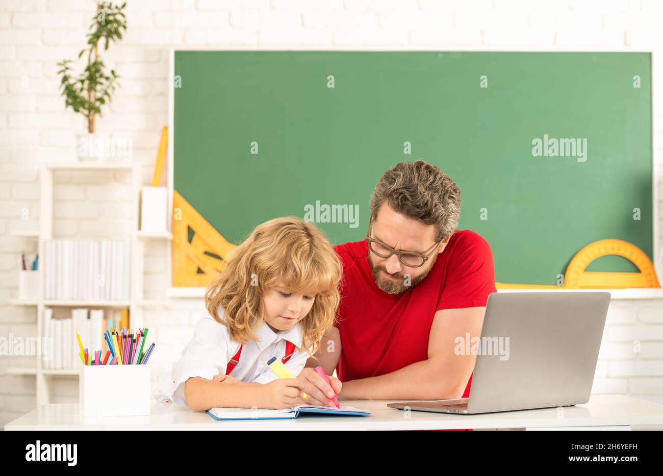teacher and child study in classroom with laptop, fatherhood Stock ...