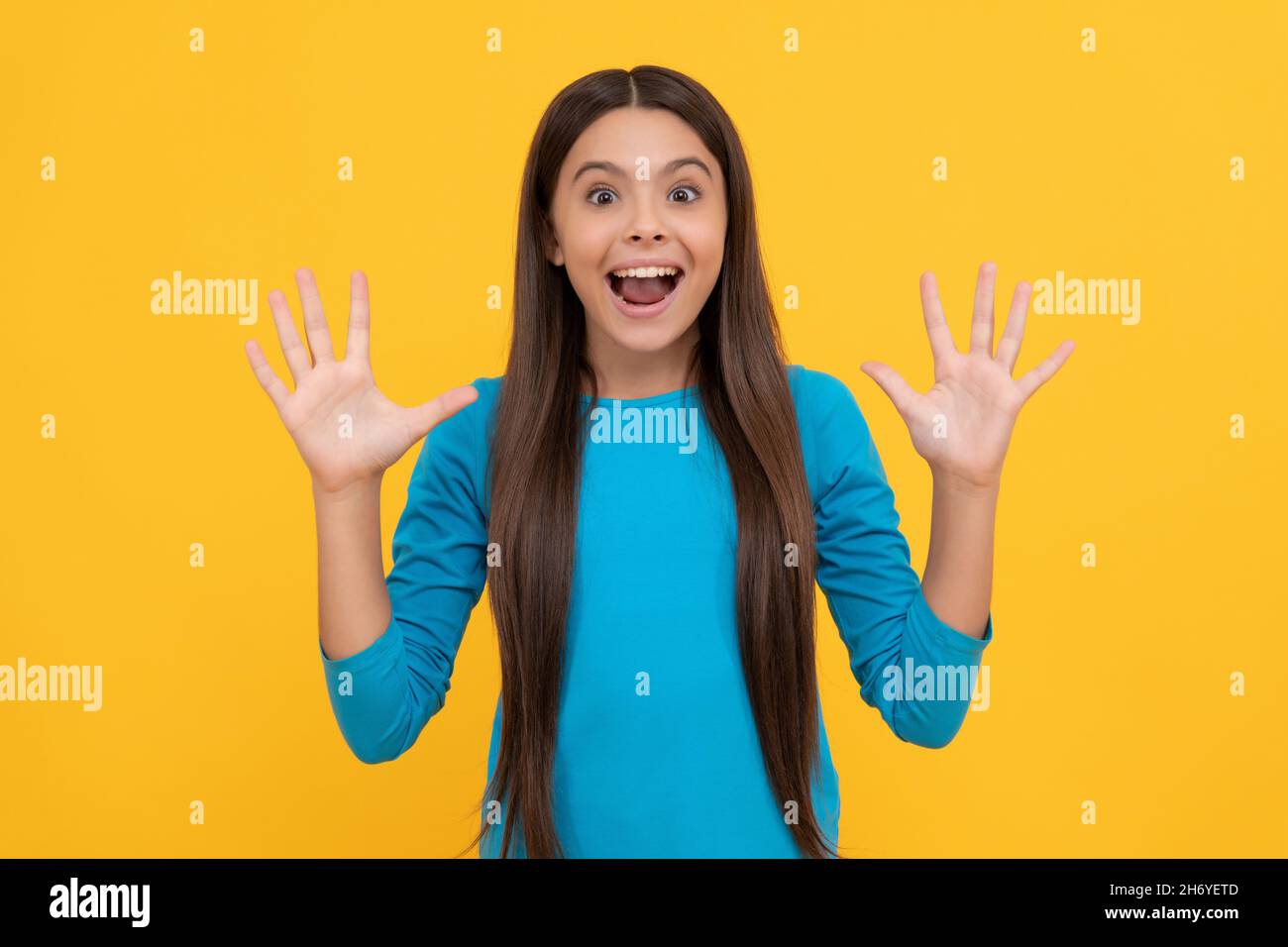 surprised face portrait of child on yellow background. express positive ...