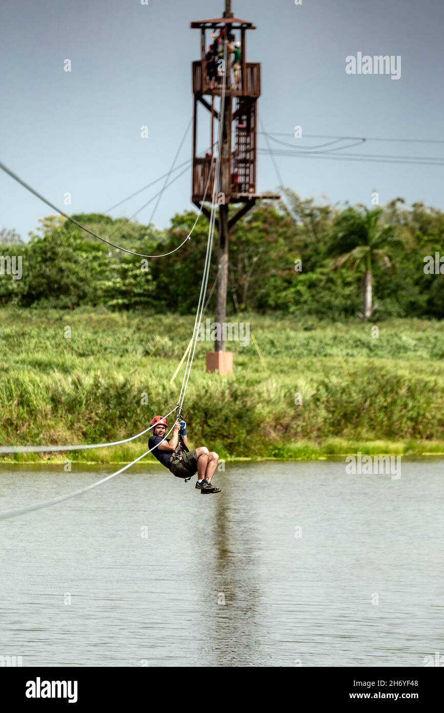 Man on zip line over lagoon, Ecoquest Adventures & Tours, Hacienda ...