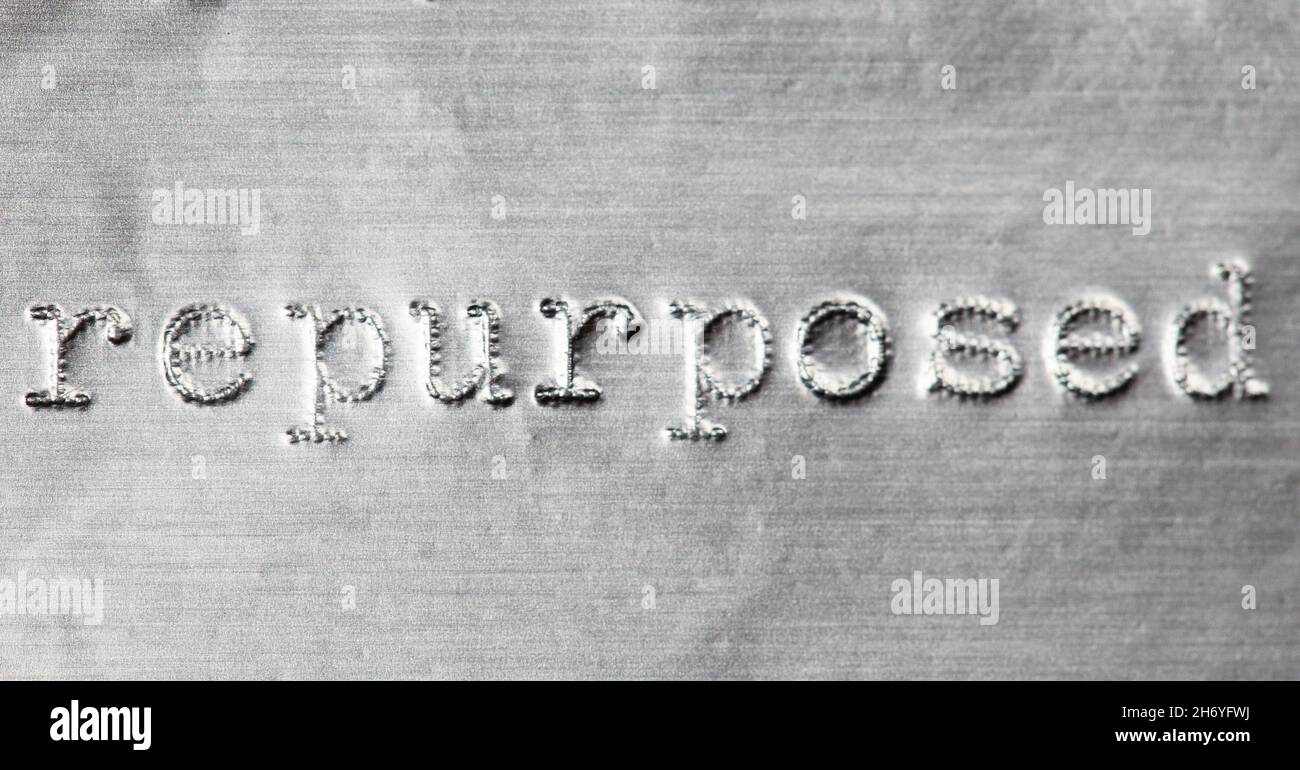 The word "repurposed" typed with old manual typewriter into shiny ...