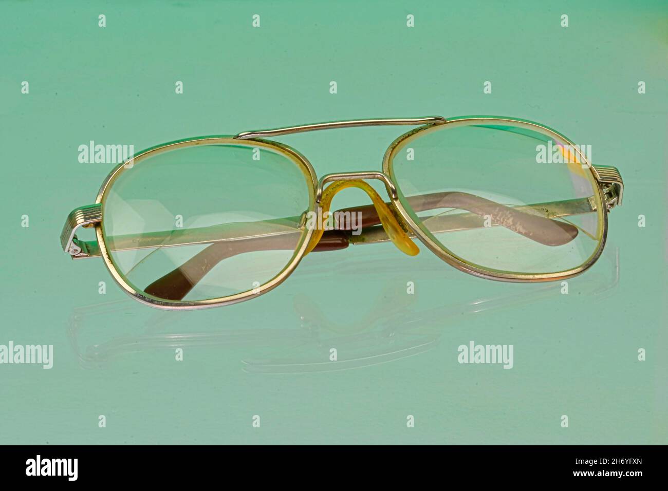 Reflection of eyeglasses. Golden eyeglasses, close-up. Eye glasses. Old ...