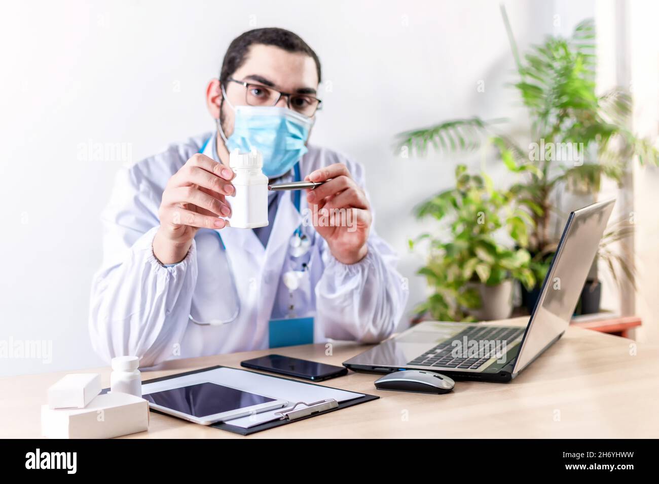 White Caucasian medical doctor showing a drug box Stock Photo - Alamy