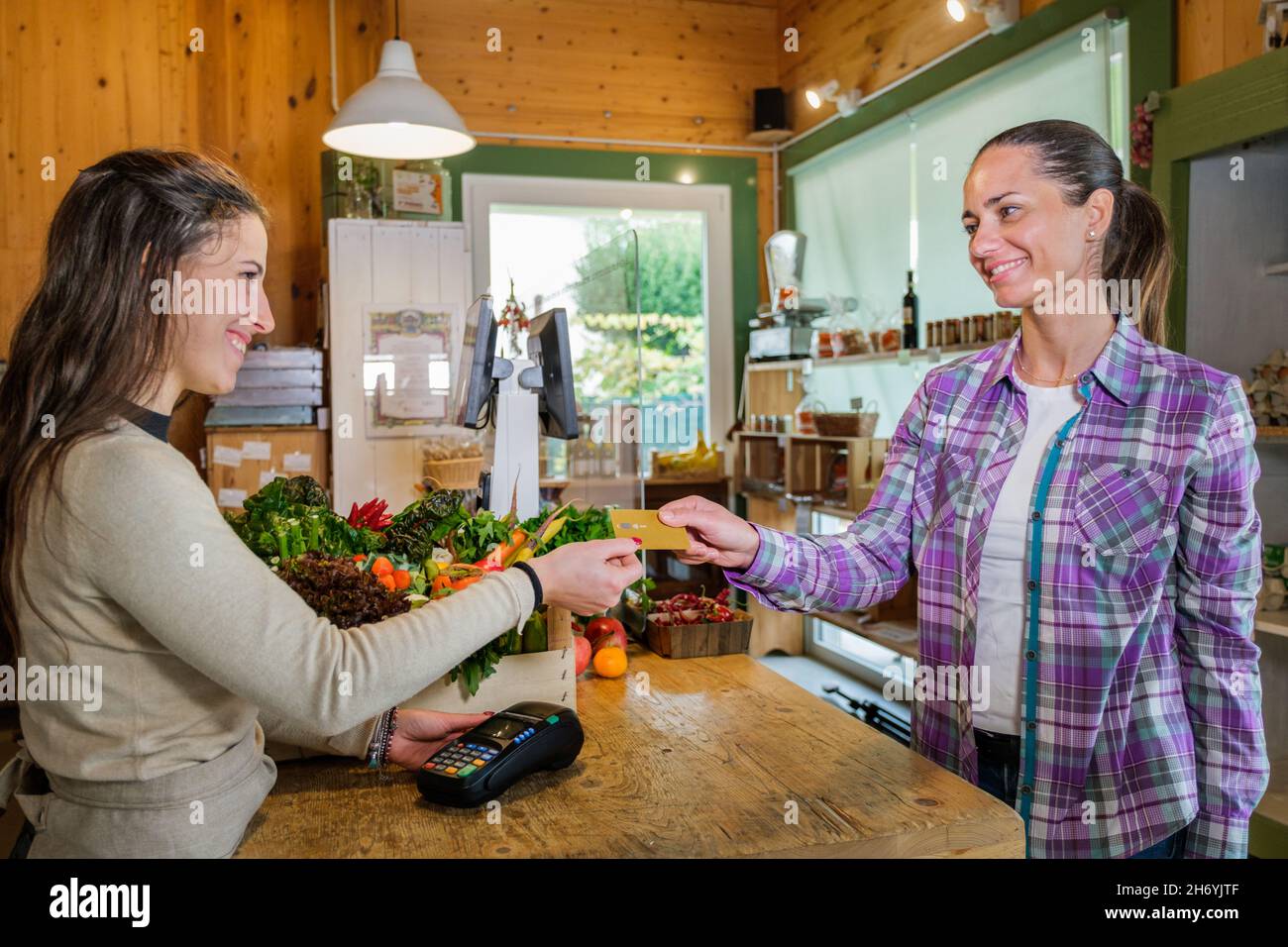 Beautiful customer girl paying for shopping at checkout in a grocery ...