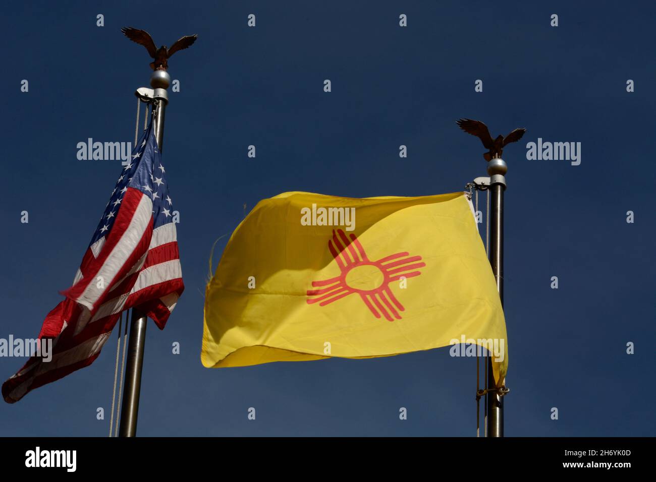 The state flag of New Mexico with its Native-American sun symbol flies ...