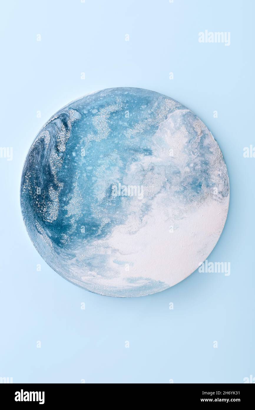 Blue scenic circle. Fluid art with ocean waves painted on round shape ...