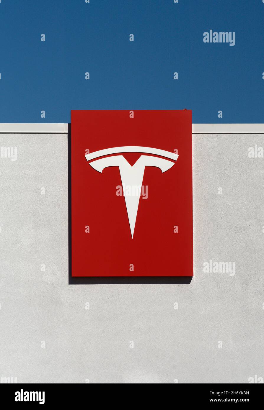 Tesla logo and signage on the exterior of a Tesla dealership and ...