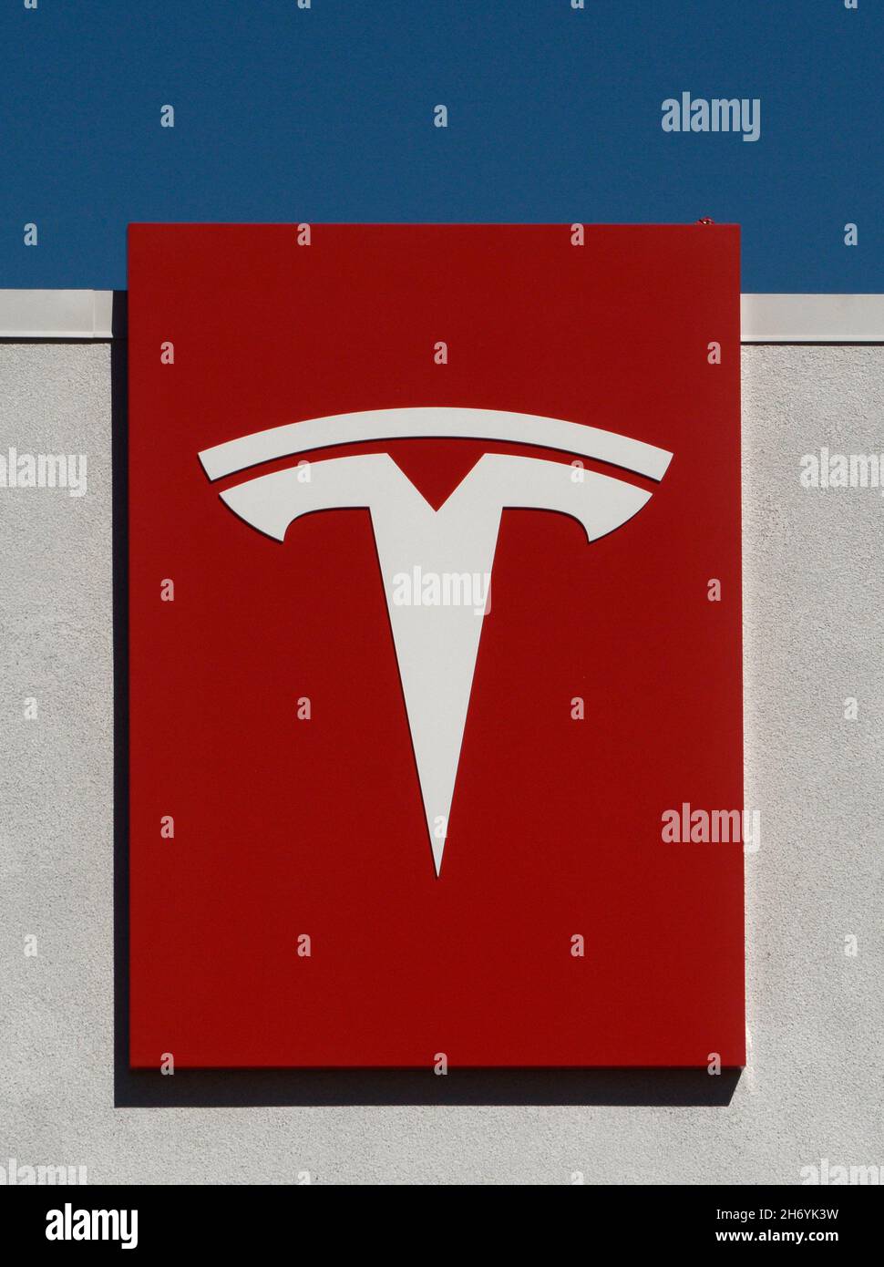 Tesla logo and signage on the exterior of a Tesla dealership and ...