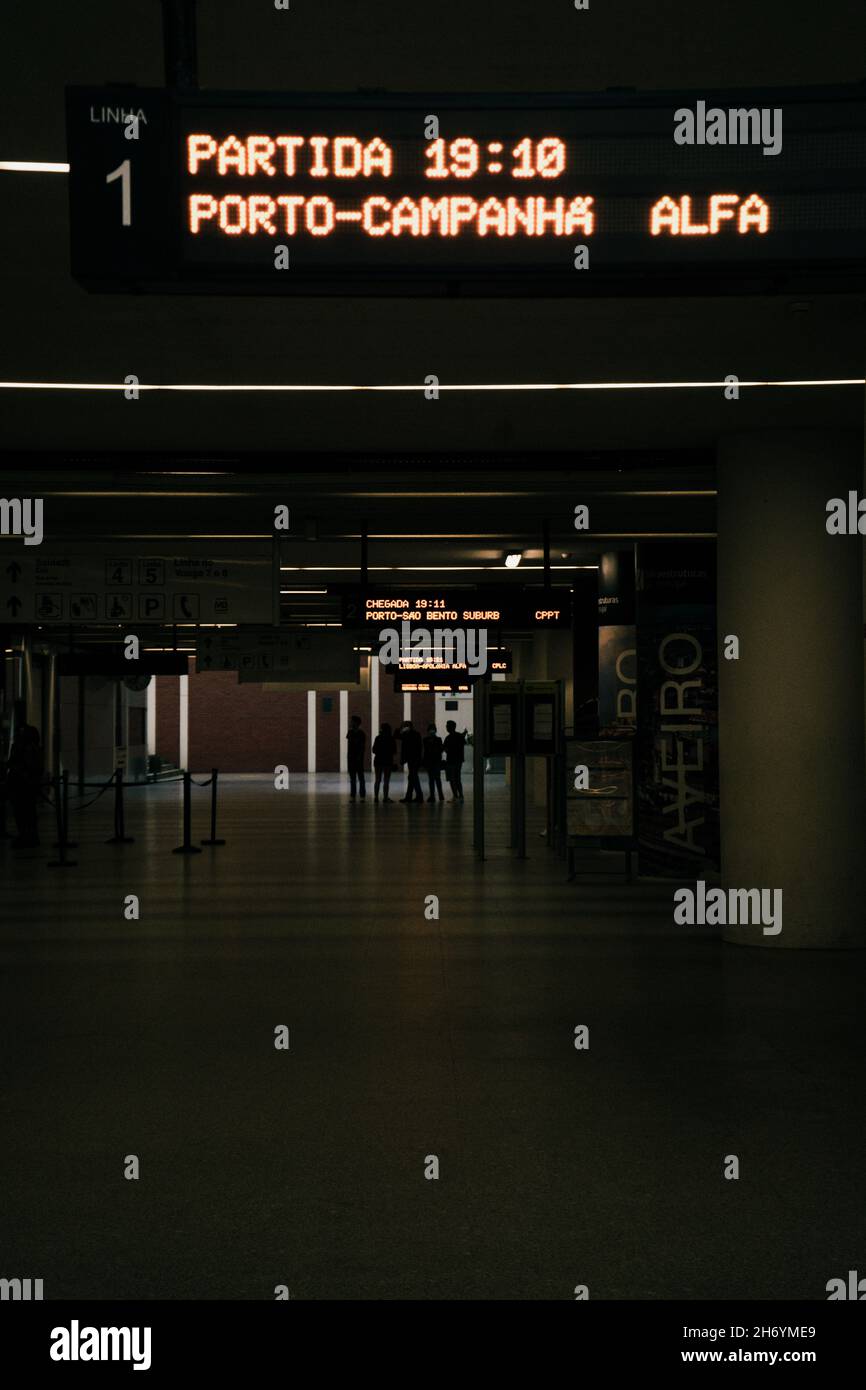 Vertical shot of a dark subway station with the name of the station and ...